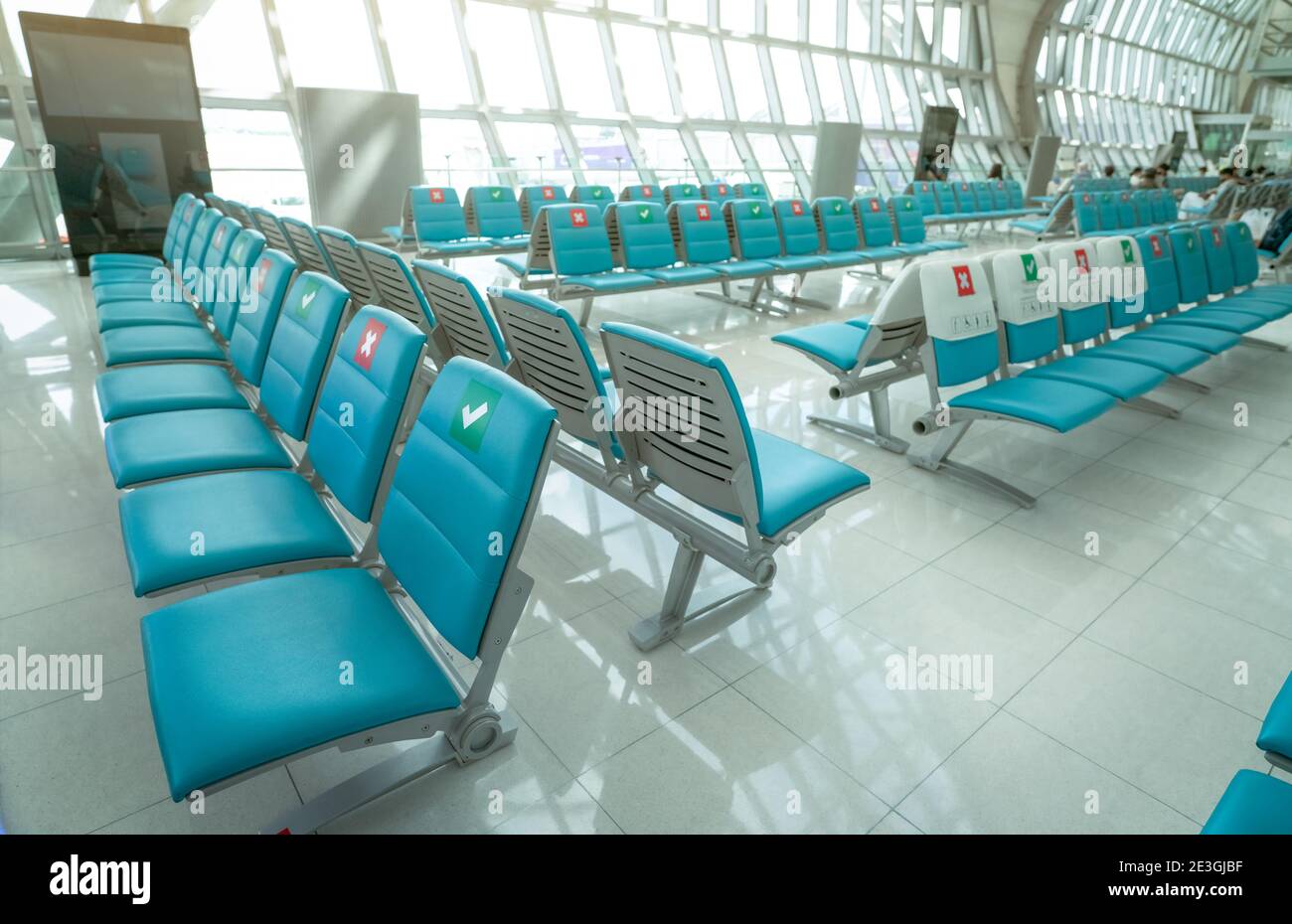 Seat in departure lounge at airport terminal. Distance for one seat ...