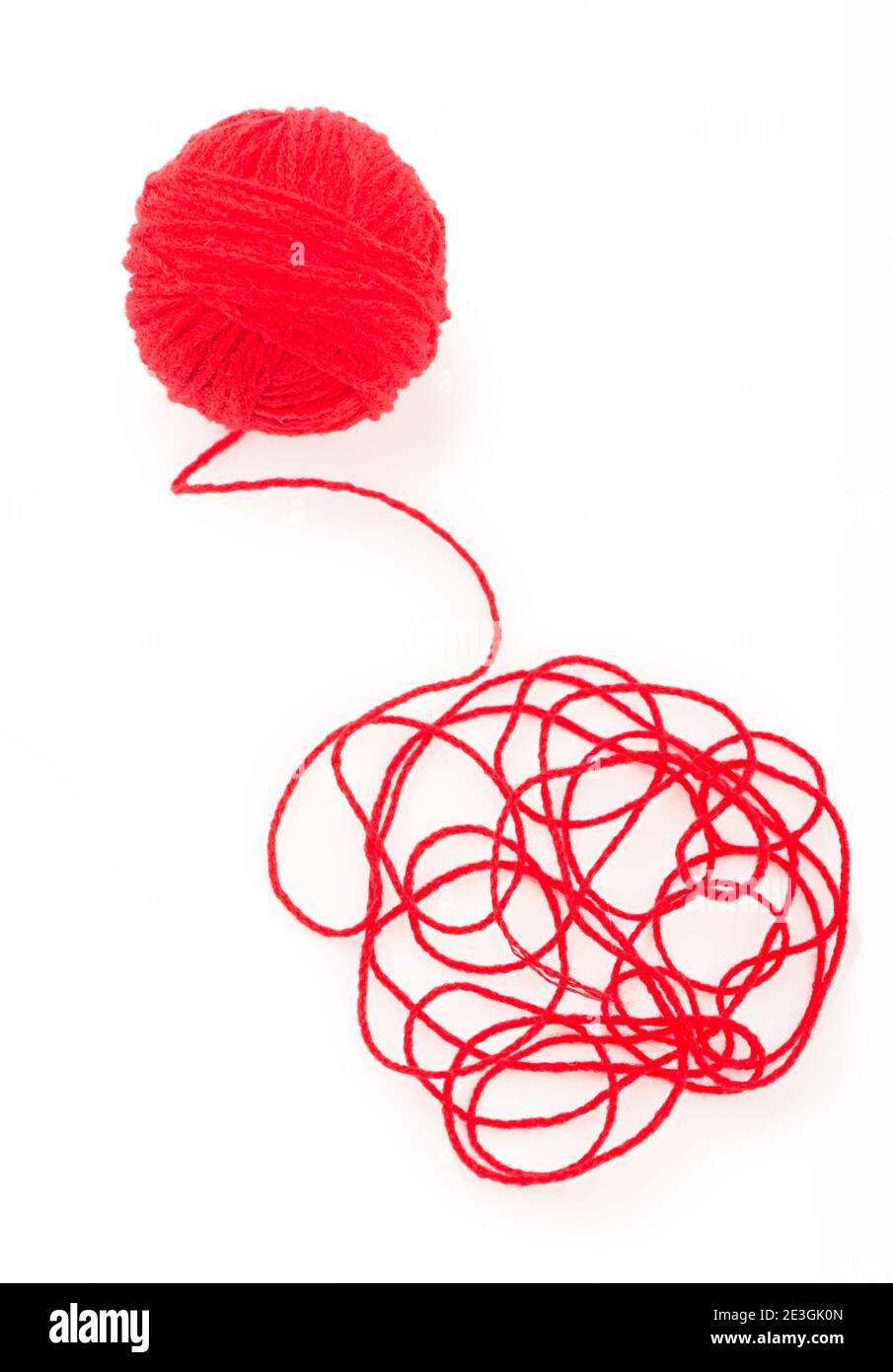 The idea is a tangled thread. Red ball of yarn on white background ...