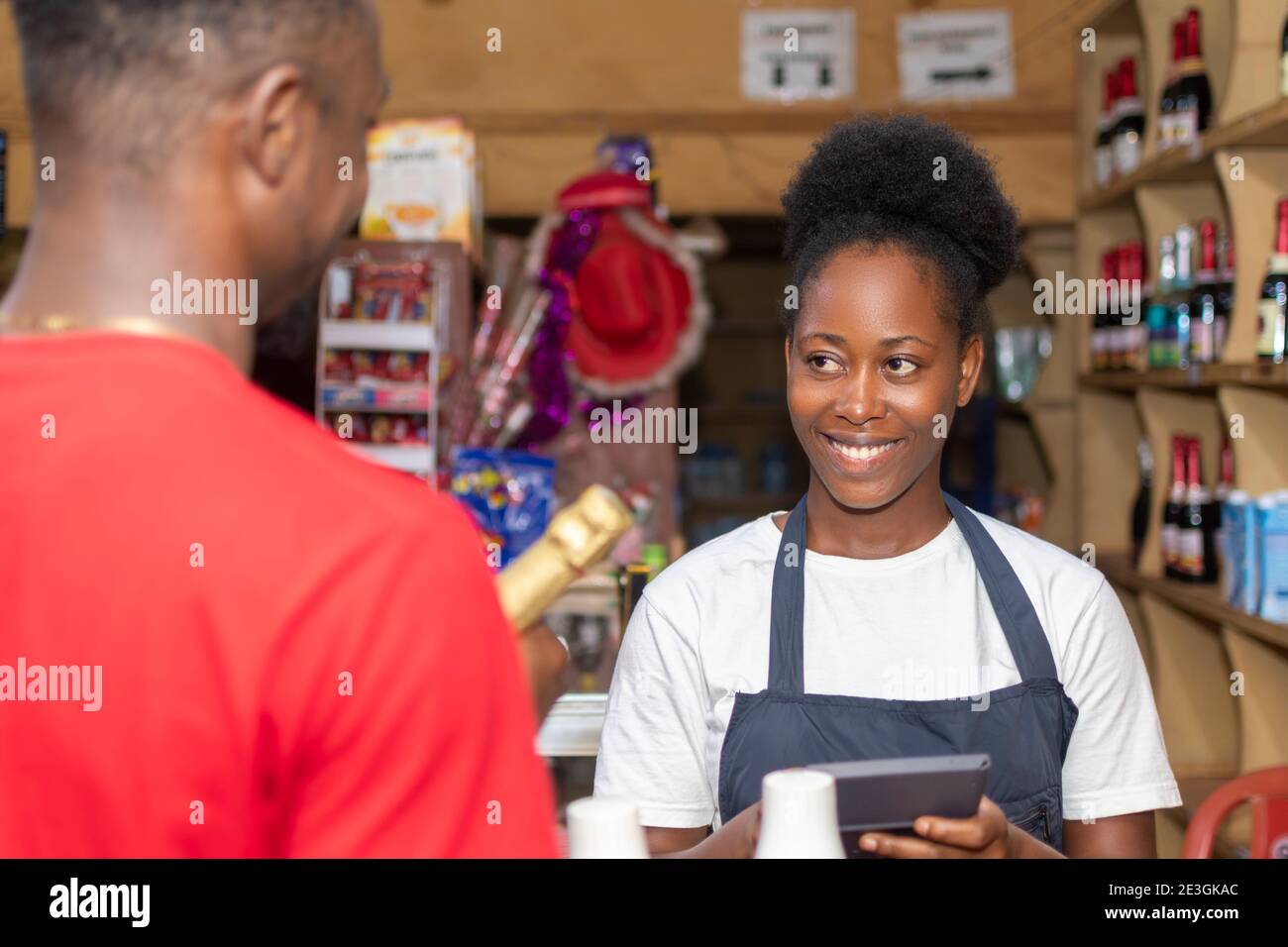 female african sales woman attending to a customer Stock Photo - Alamy
