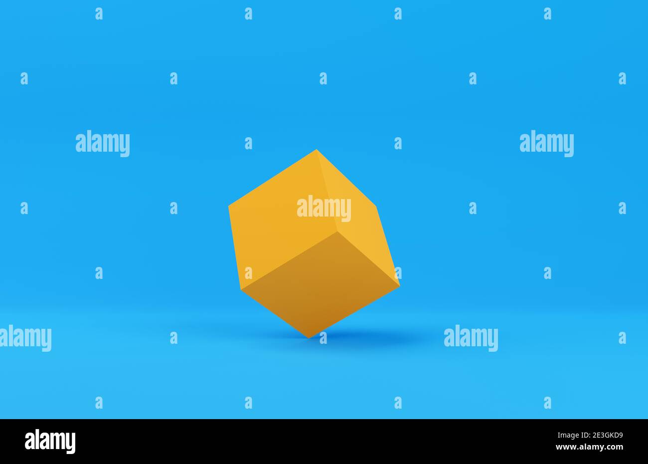 Orange cube box primitive geometry on blue background with copy space ...