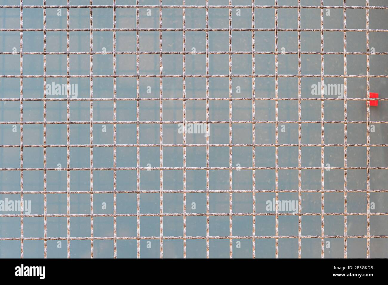A metal grid background. Protective mesh on a light blue background ...