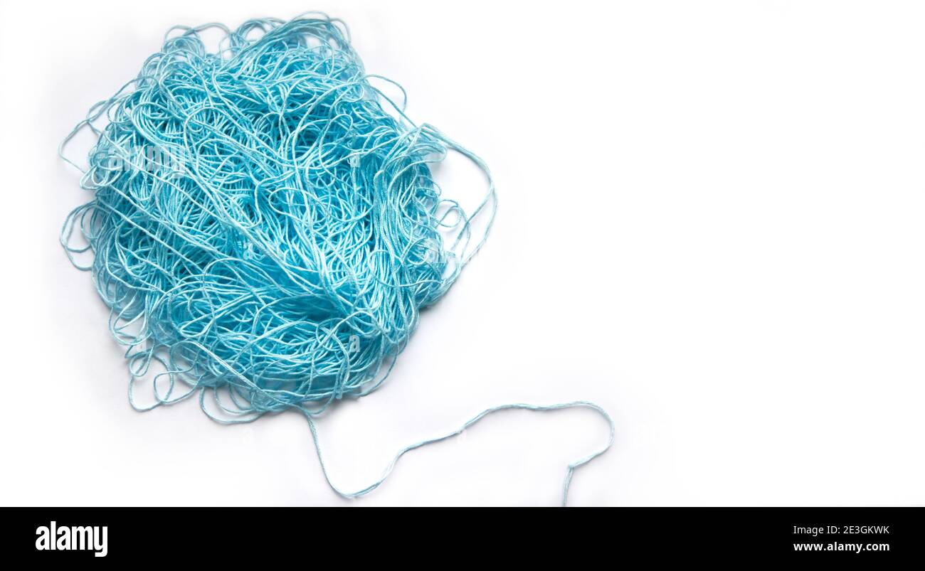 The concept of brainstorming. A tangle of mint, blue cotton threads ...