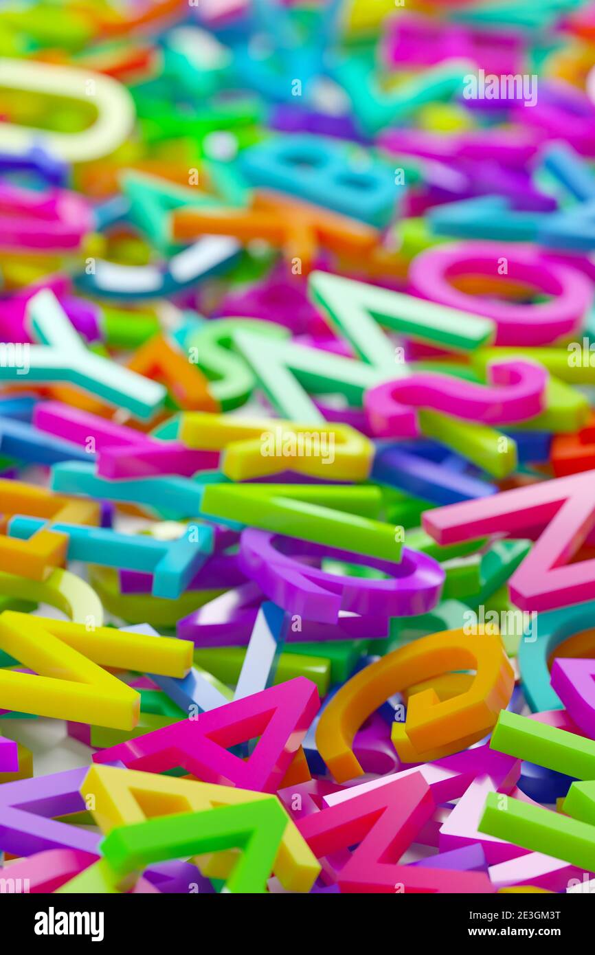 Heap of colorful rainbow alphabetic plastic character letters ...