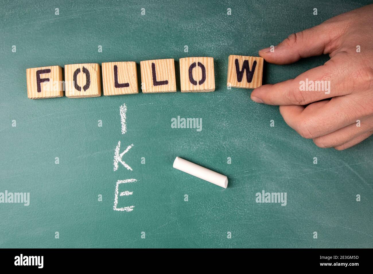 Follow and Like concept. Text from letters of the wooden alphabet on a ...