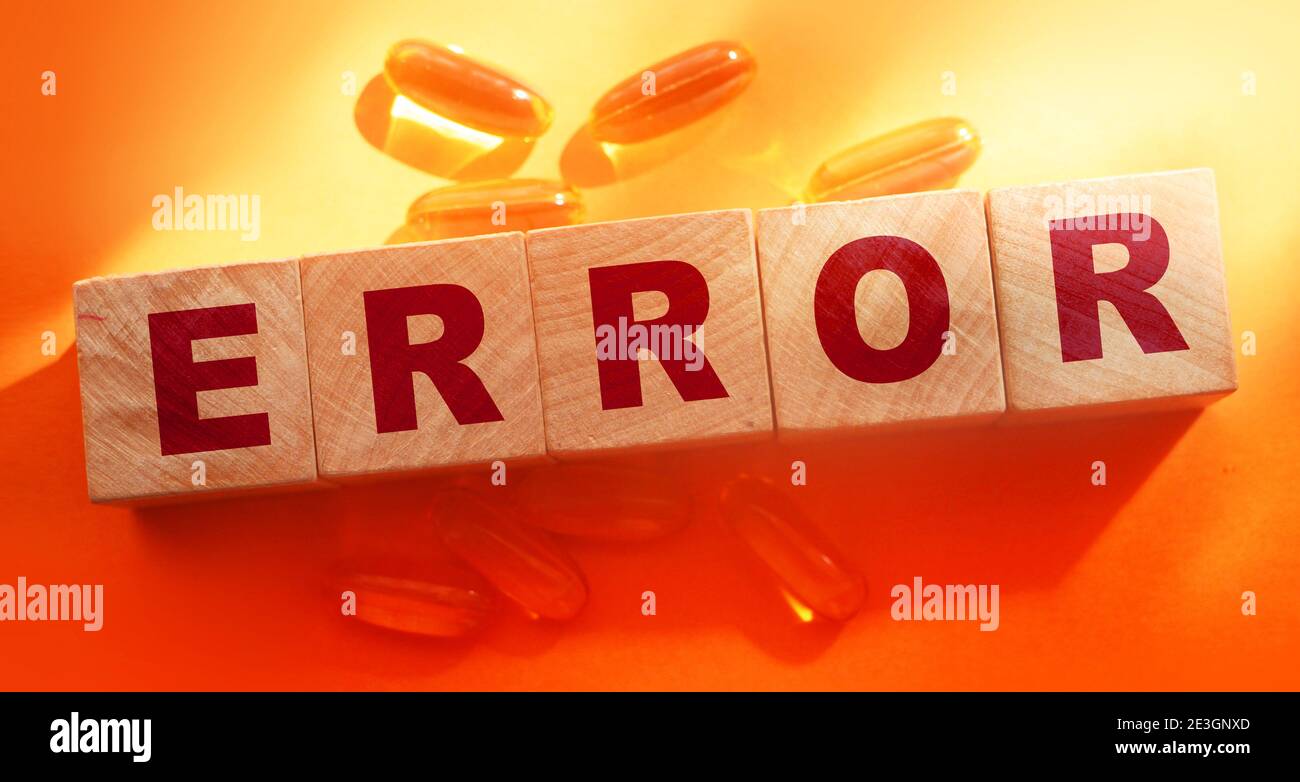 Error Word In Wooden Cubes and Omega-3 capsules tabs on orange ...