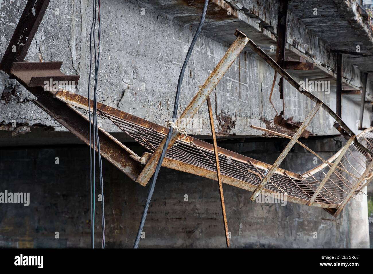 Close up of a broken metal walkway on an old reinforced concrete bridge ...