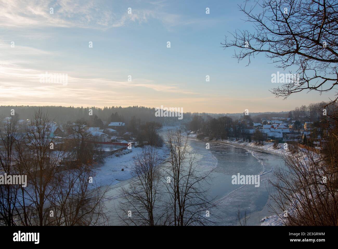 Winter frosty landscape. Frozen river, village covered with snow on the ...