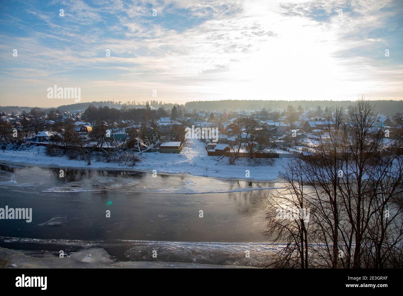 Winter frosty landscape. Frozen river, village covered with snow on the ...