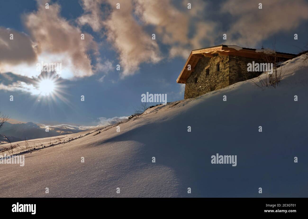 traditional french alpine chalet at the top of snowy mountain at sunset ...