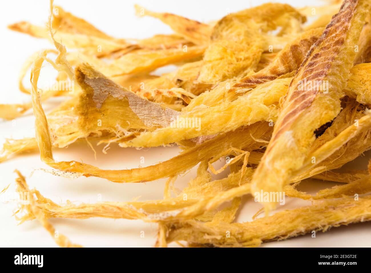 Dried pollack on white background Stock Photo - Alamy