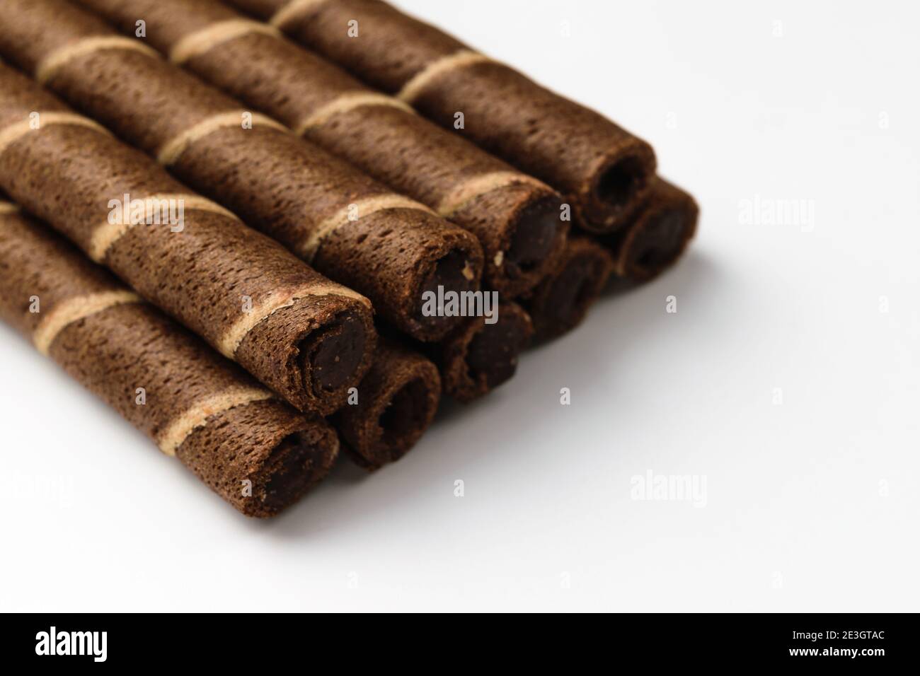 Chocolate wafer rolls on a white background Stock Photo - Alamy