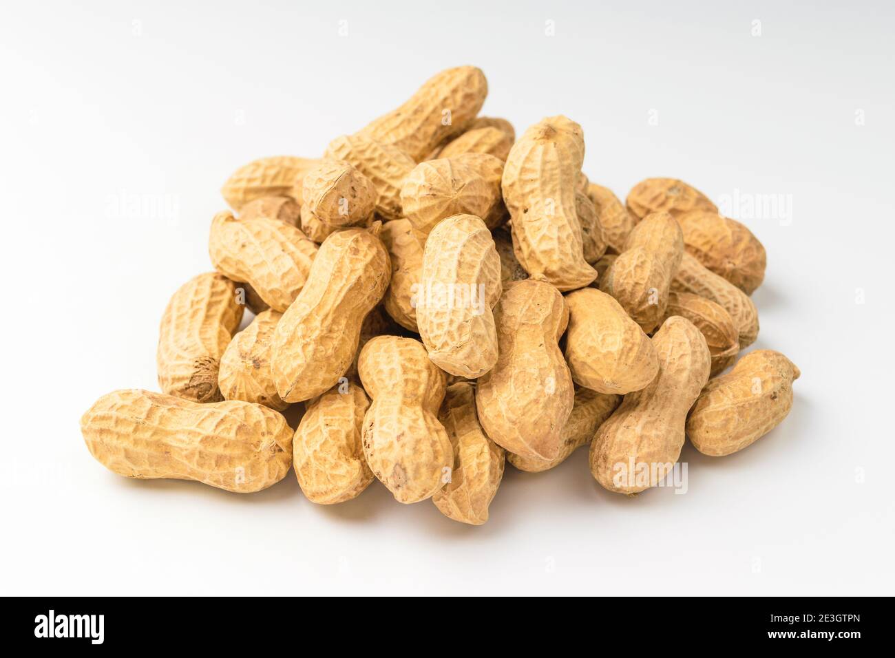 Raw peanuts on a white background Stock Photo - Alamy