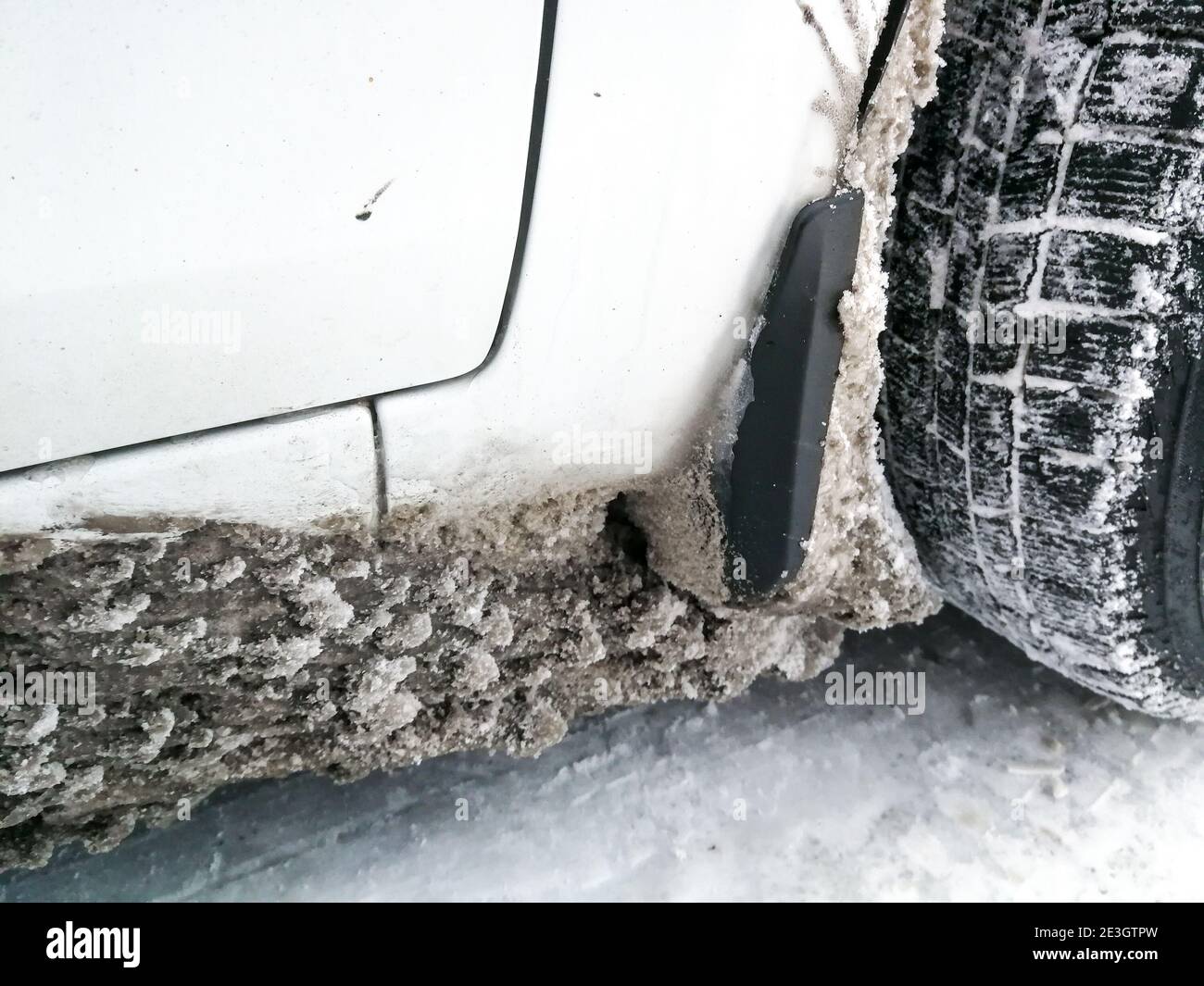 The wheel arch of the car is clogged with ice and snow. Consequences of ...