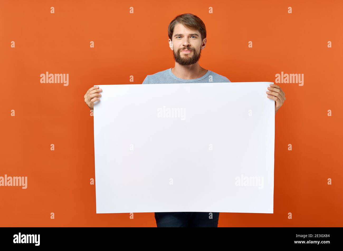 white sheet of paper ad advertisement man in the background orange ...