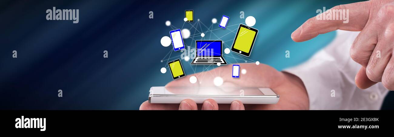 Devices connection concept above a smartphone held by a man Stock Photo ...