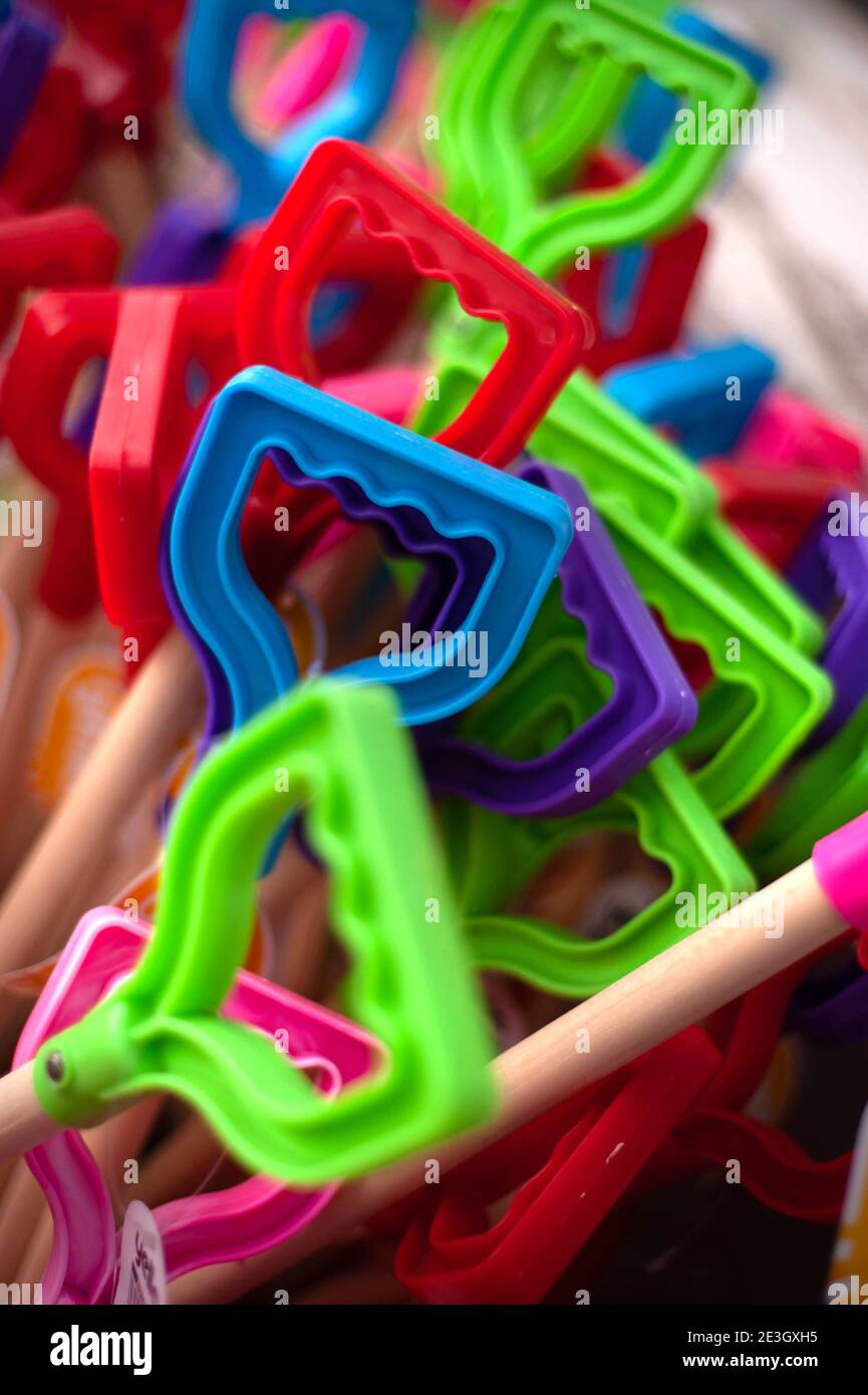 Plastic spades in Seahouses shop, Northumberland Stock Photo - Alamy