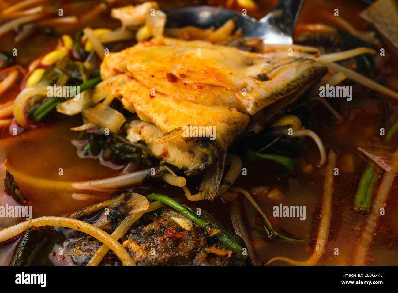 Cooking fish broth on a white background Stock Photo - Alamy