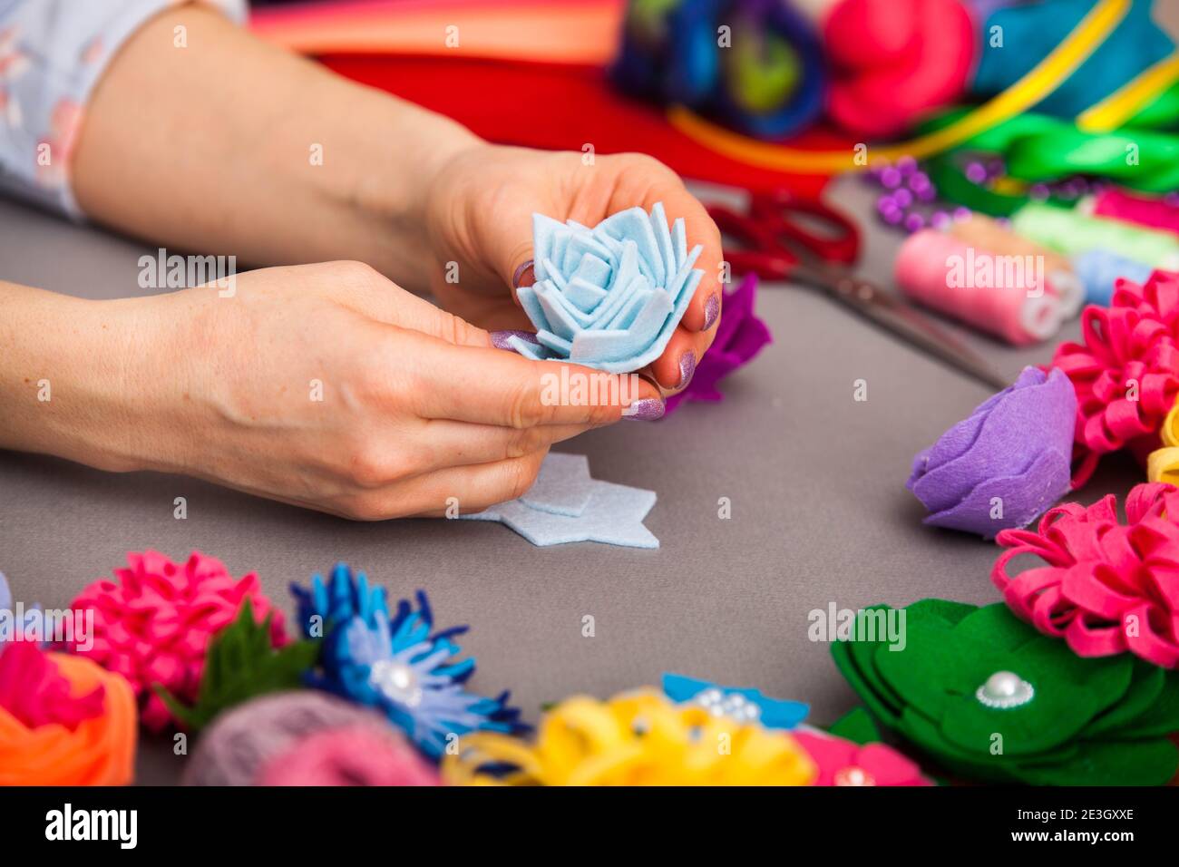 Woman modelling artificial flower from clay Stock Photo - Alamy