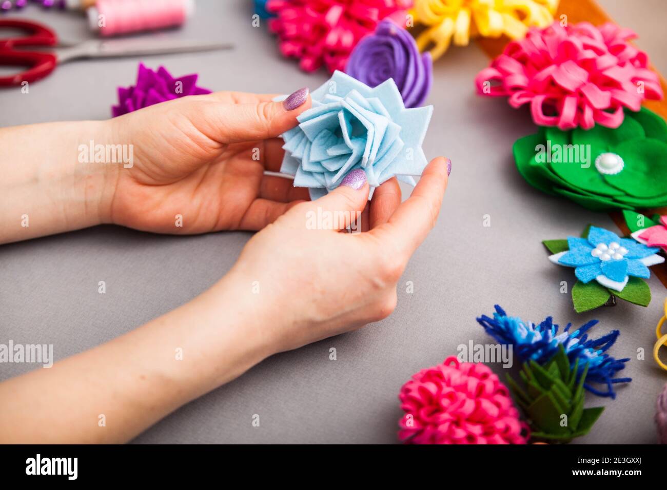 Woman modelling artificial flower from clay Stock Photo - Alamy