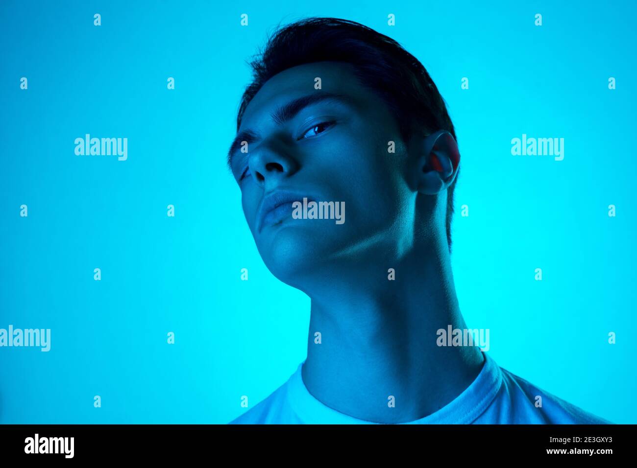Proud. Handsome caucasian man's portrait isolated on blue studio ...