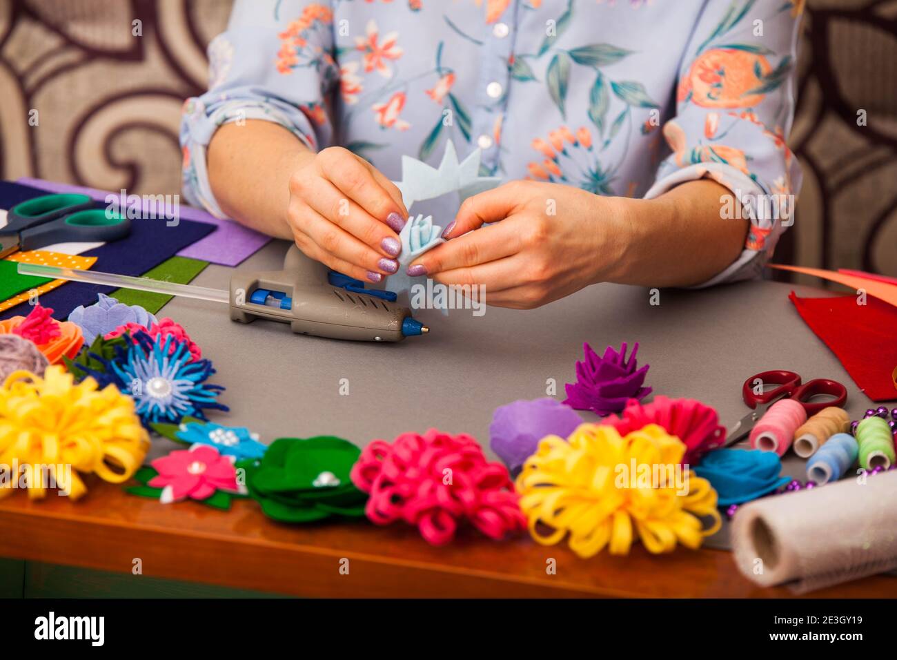 Woman modelling artificial flower from clay Stock Photo - Alamy