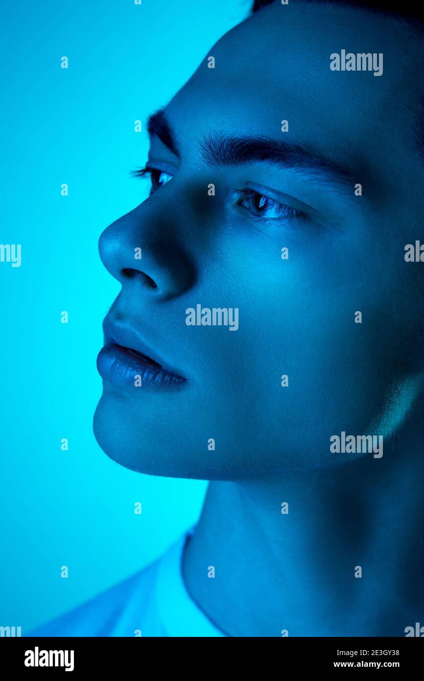 Calm. Handsome caucasian man's portrait isolated on blue studio ...
