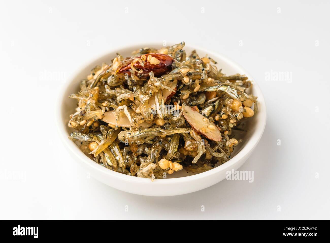 Stir-fried anchovies on white background Stock Photo - Alamy