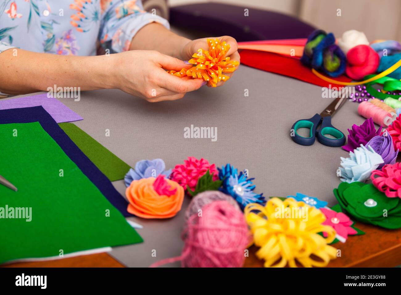 Woman modelling artificial flower from clay Stock Photo - Alamy