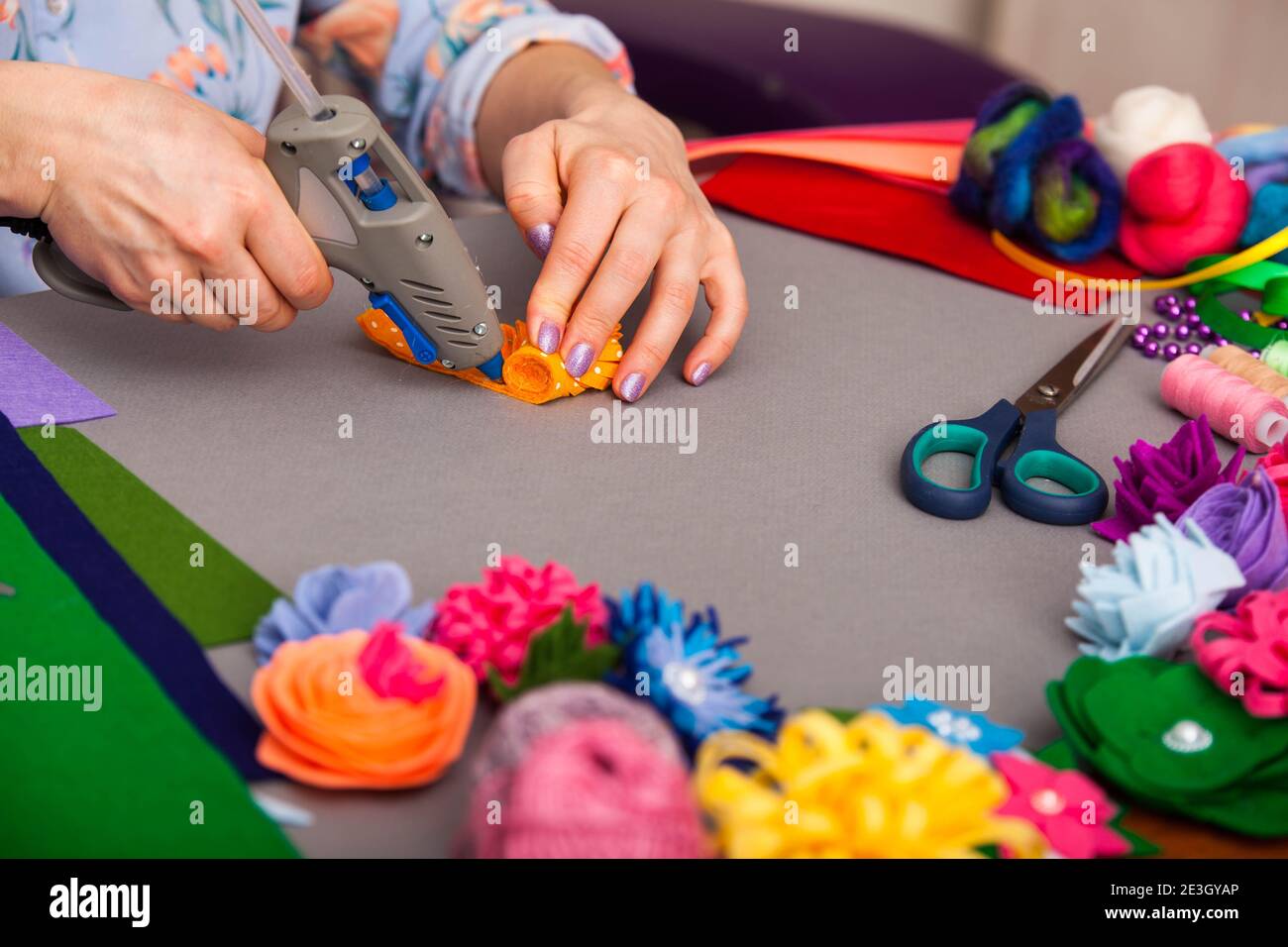 Woman modelling artificial flower from clay Stock Photo - Alamy