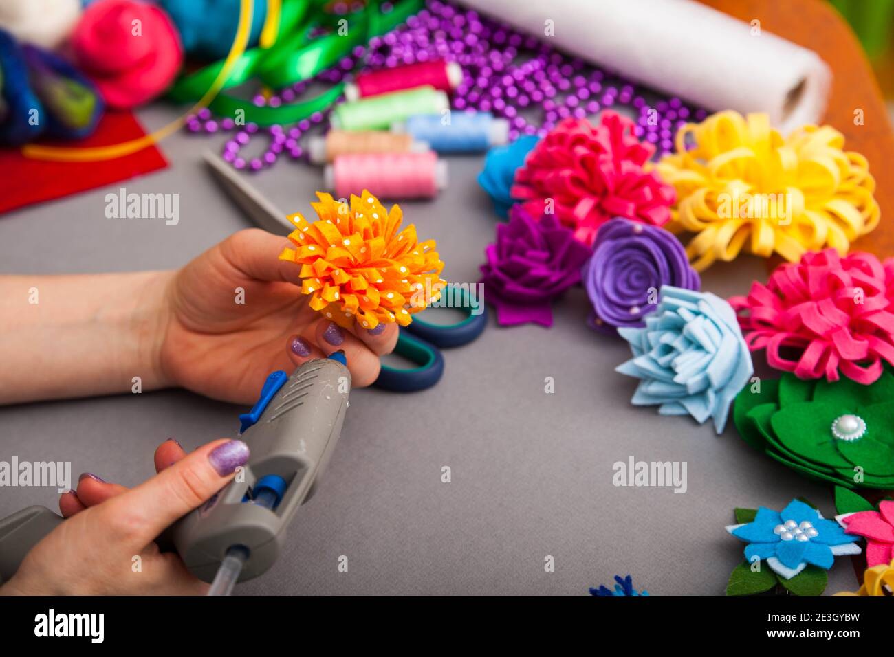 Woman modelling artificial flower from clay Stock Photo - Alamy
