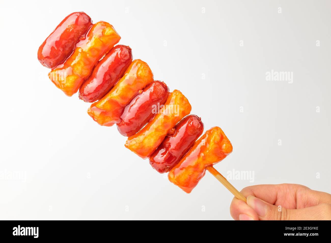 Sausage rice cake skewers on a white background Stock Photo - Alamy