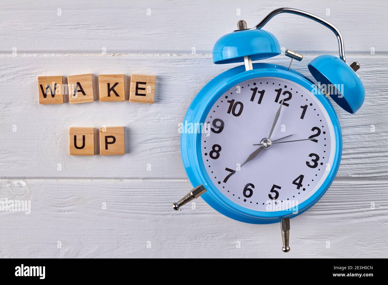Vintage blue alarm clock on white background Stock Photo - Alamy