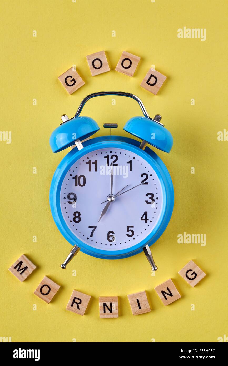 Blue bell clock and good morning wish Stock Photo - Alamy