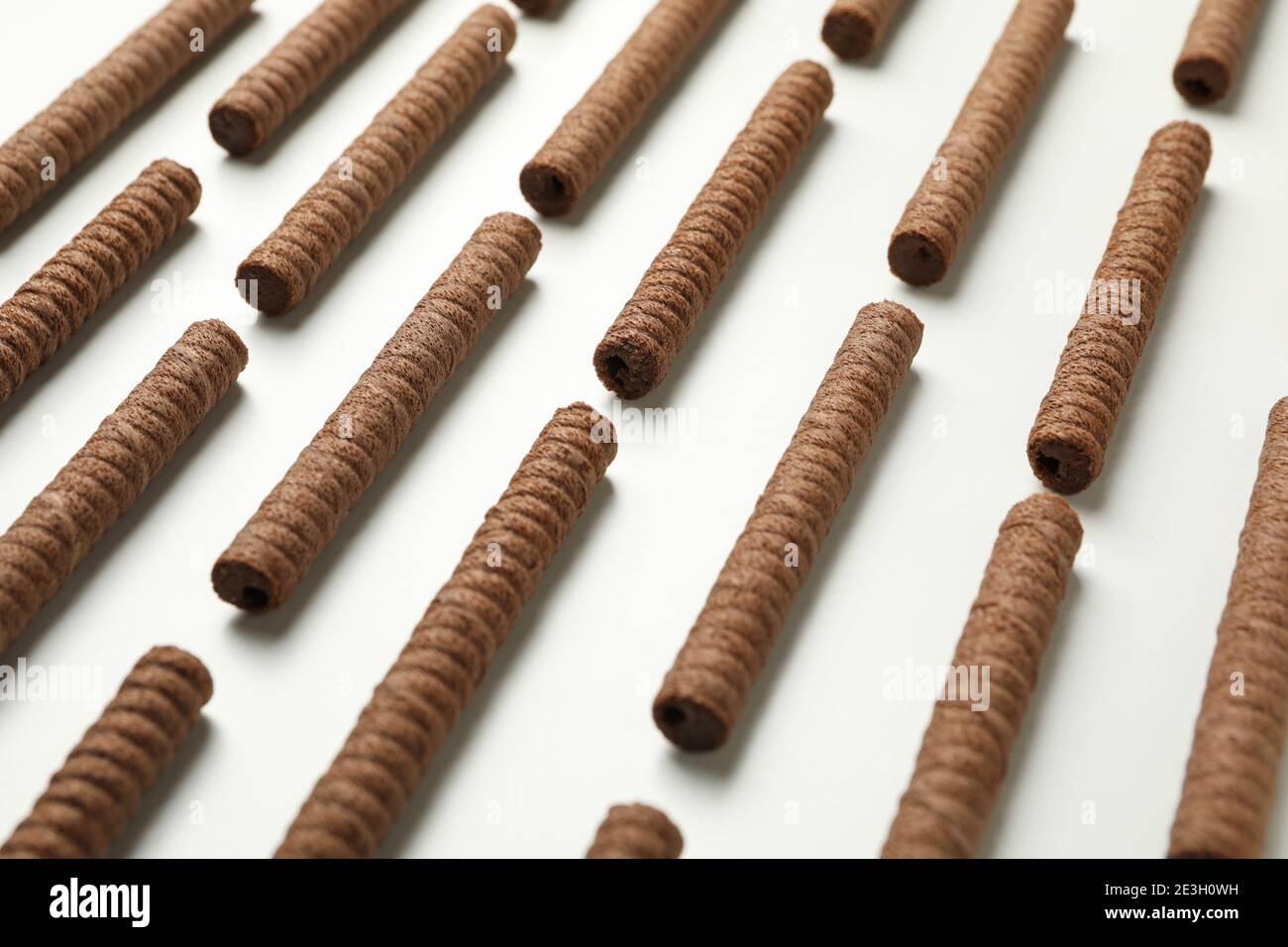 Flat lay with chocolate wafer rolls on white background Stock Photo - Alamy