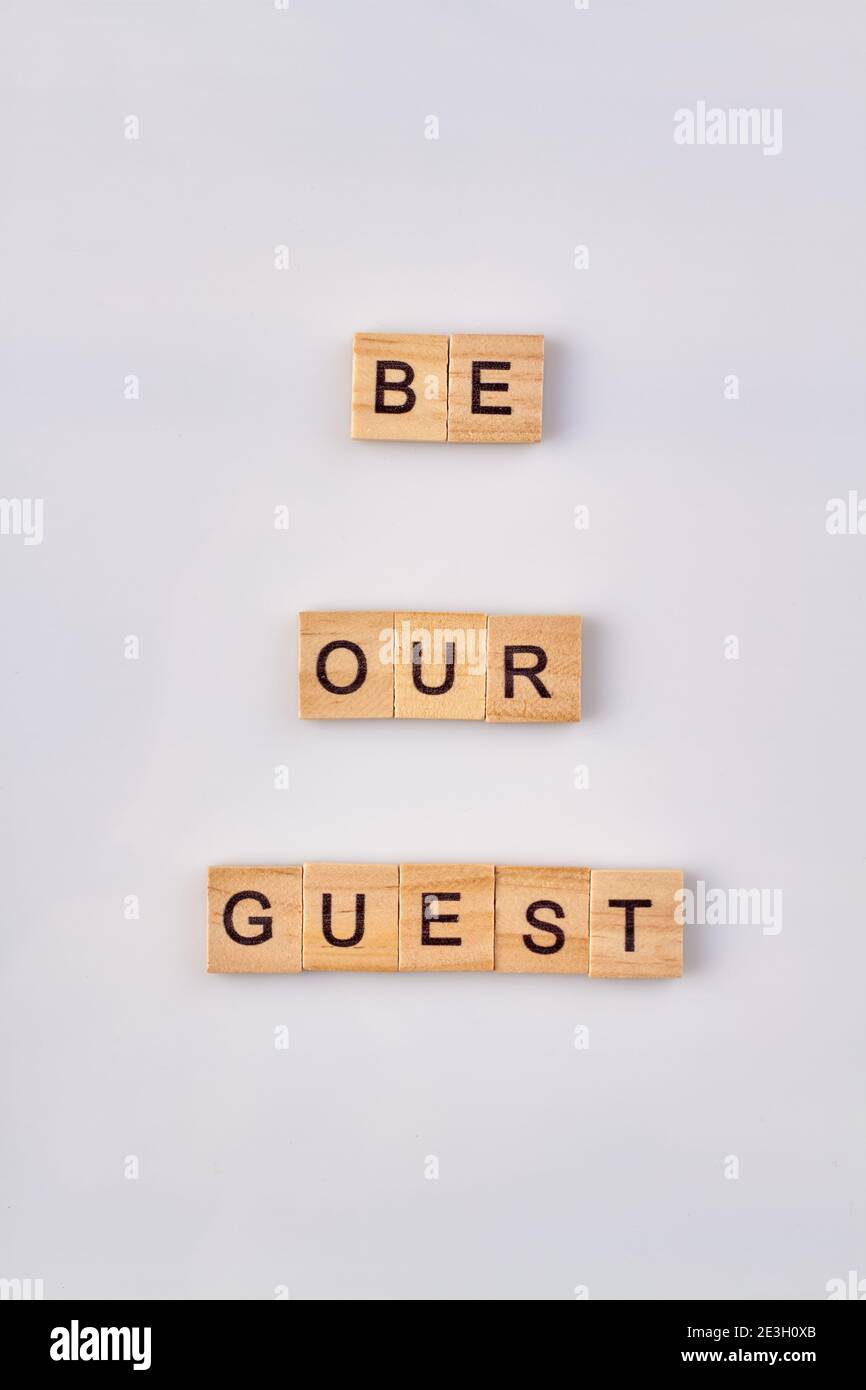 Be our guest wooden words Stock Photo - Alamy
