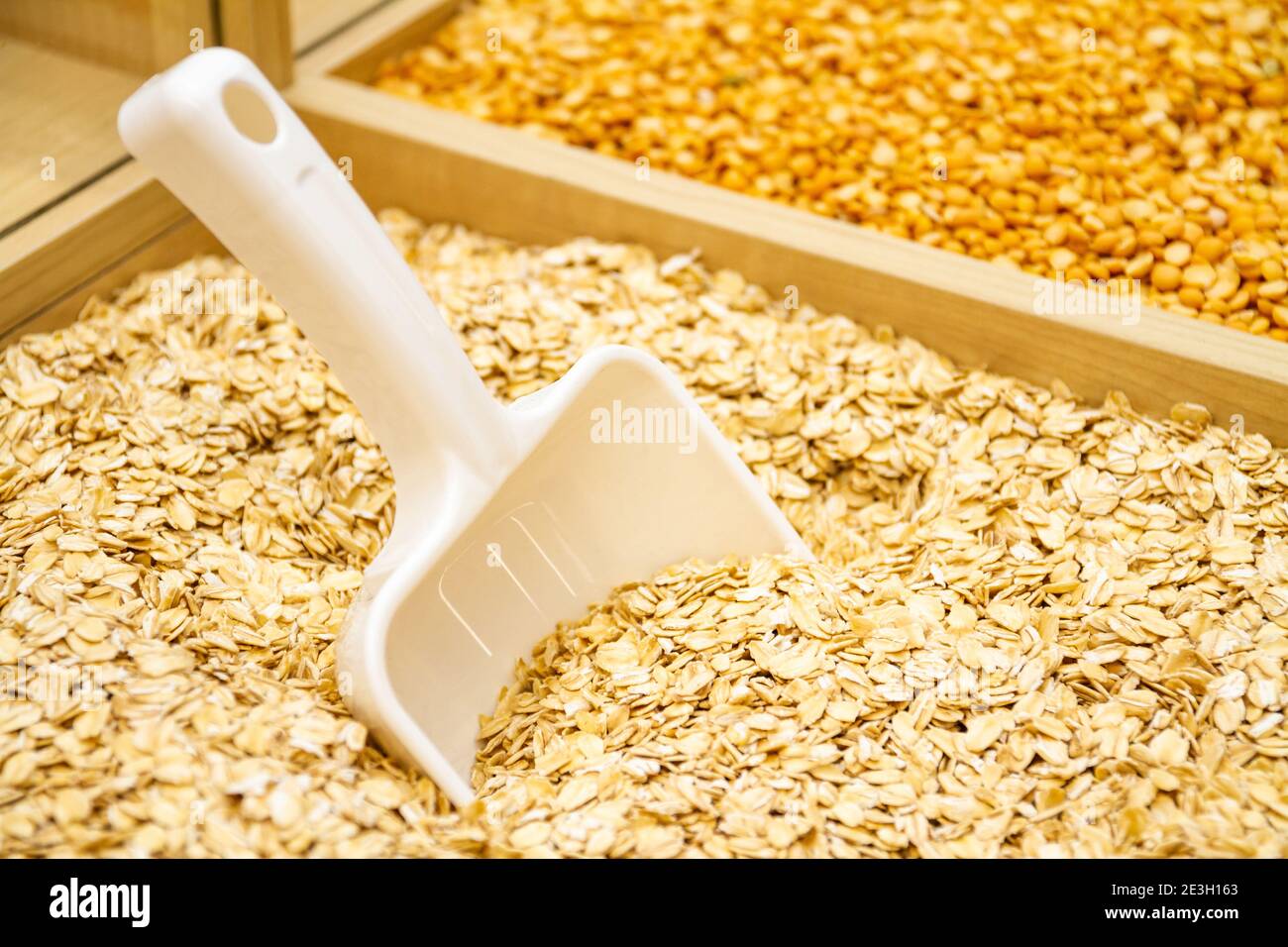 Oatmeal in a tray with a plastic grain spatula in a supermarket Stock ...