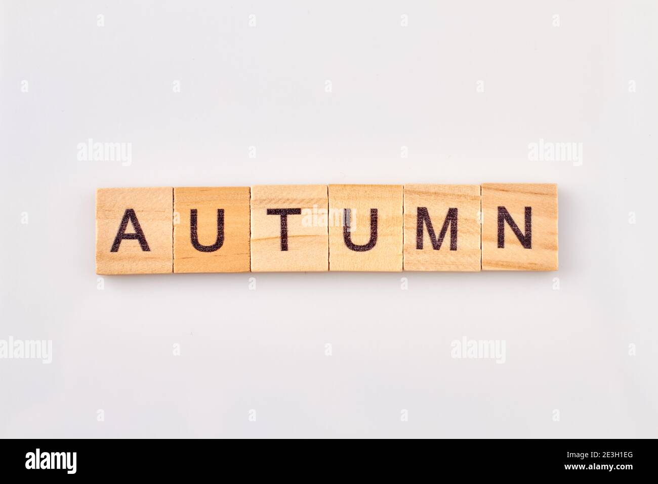 Autumn word written on wooden block Stock Photo - Alamy