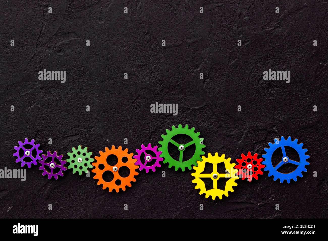 Teamwork concept. Gears connect in working mechanism, overhead view ...