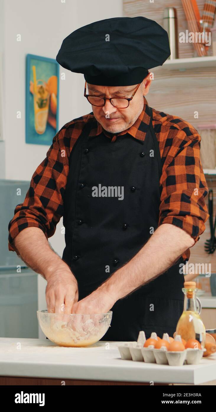 Elderly chef uniform sprinkling hi-res stock photography and images - Alamy