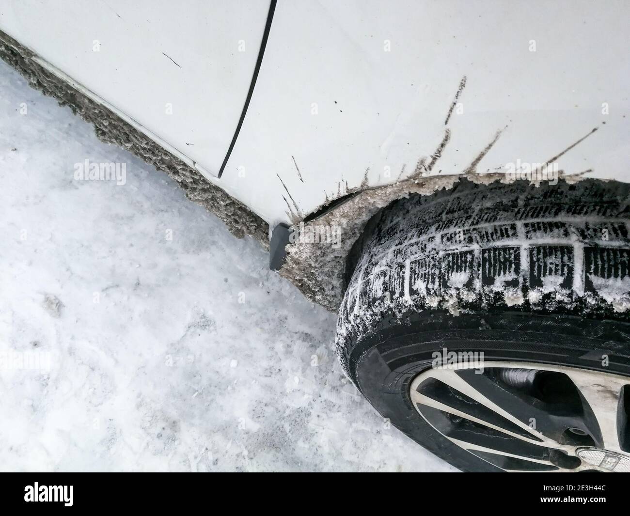 The wheel arch of the car is clogged with ice and snow. Consequences of ...