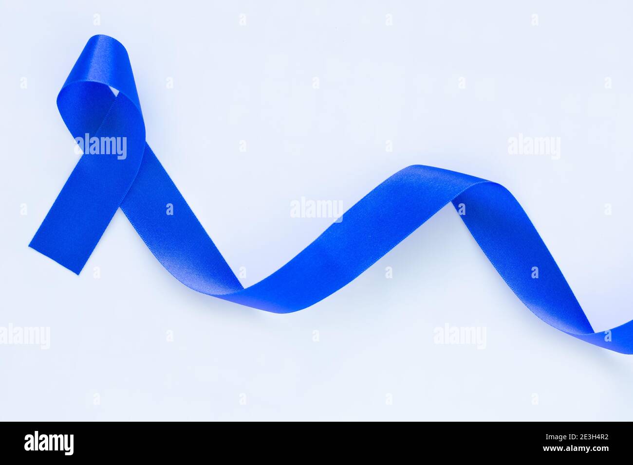 Deep blue ribbon curl on white fabric with copy space. Colorectal ...