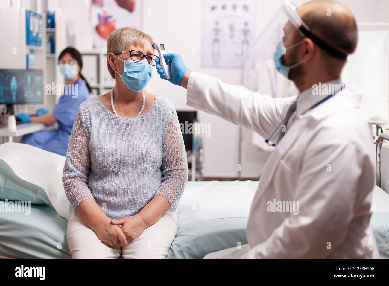 Checking temperature patient forehead thermometer hi-res stock ...