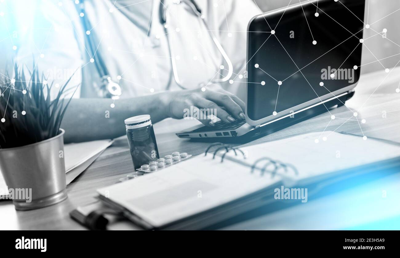 Female doctor using laptop in medical office; light effect Stock Photo ...