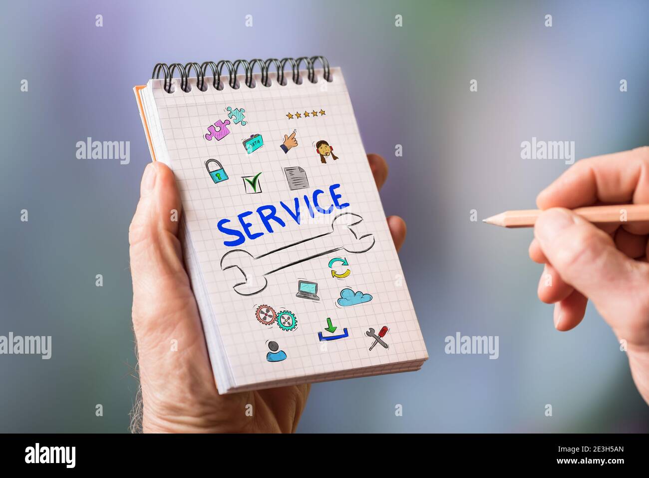 Hand drawing customer service concept on a notepad Stock Photo - Alamy