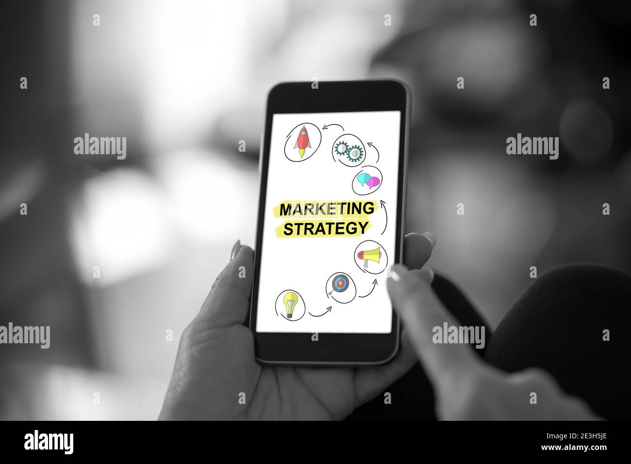 Hand holding a smartphone with marketing strategy concept Stock Photo ...