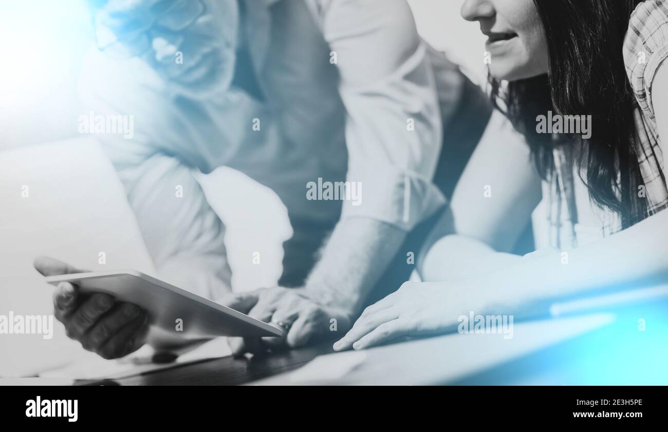 Young businesswoman and senior businessman working together at office ...