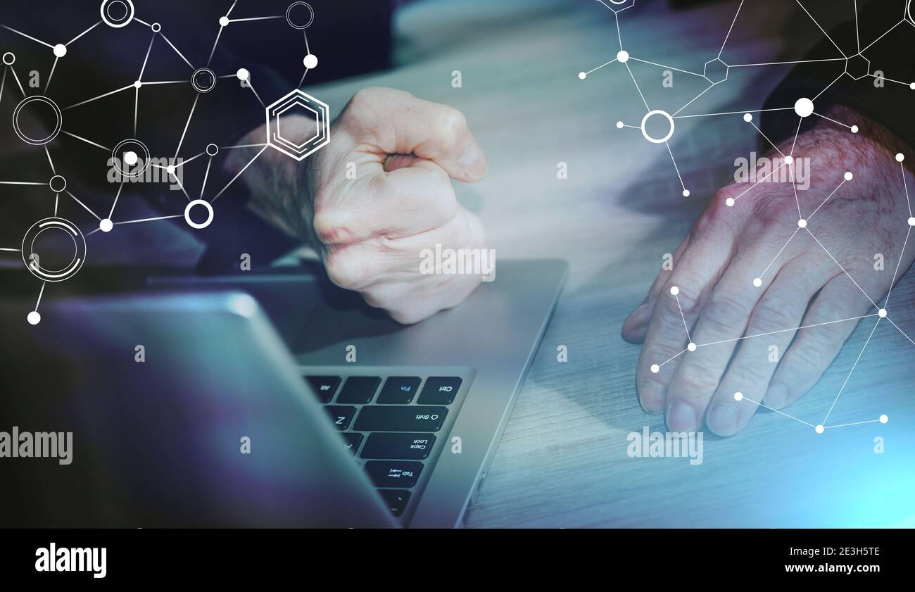 Angry businessman hitting his laptop with his clenched fist; light ...
