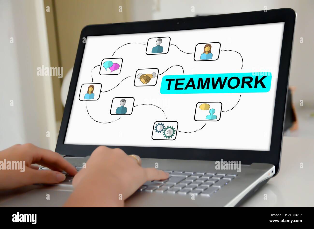 Hands on a laptop with screen showing teamwork concept Stock Photo - Alamy