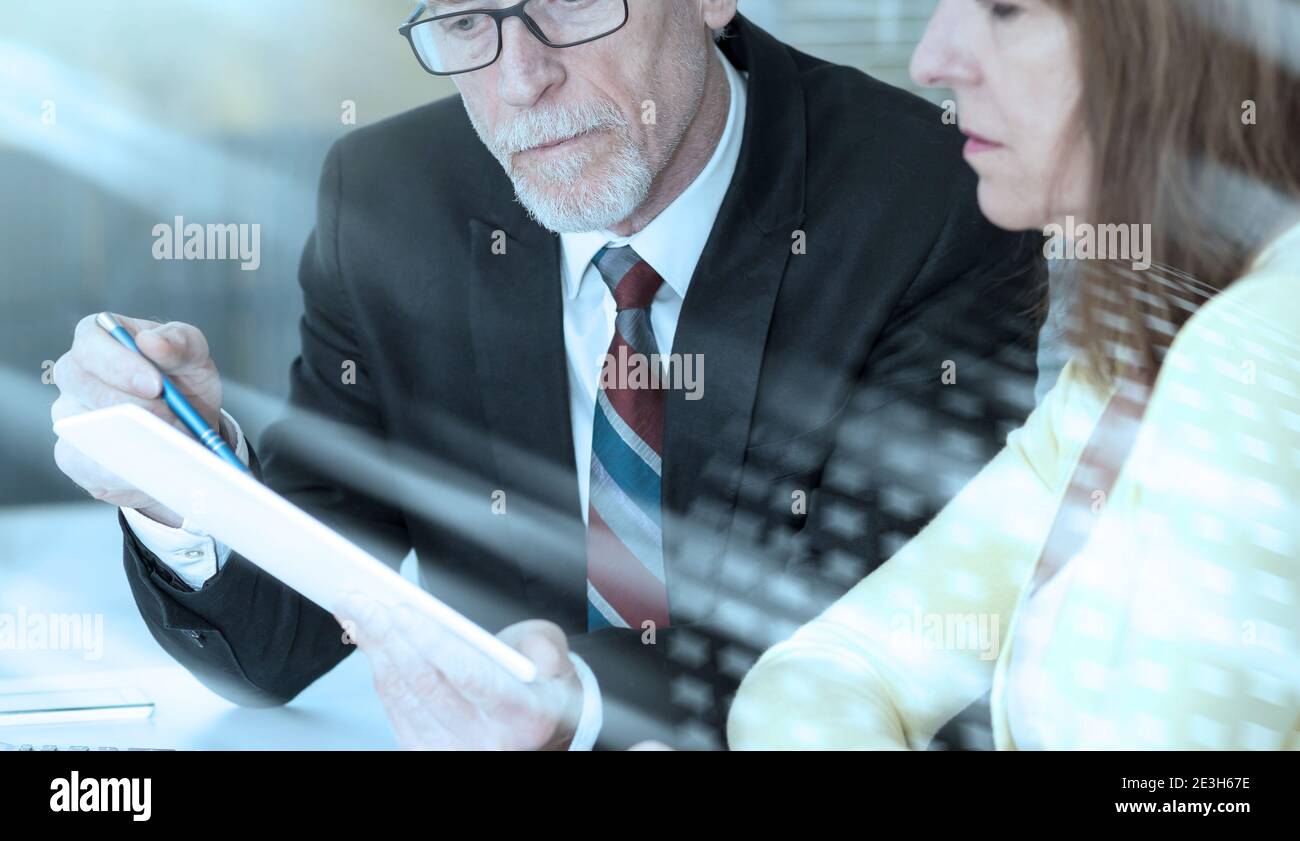 Financial consultant giving advices to female client, light effect ...