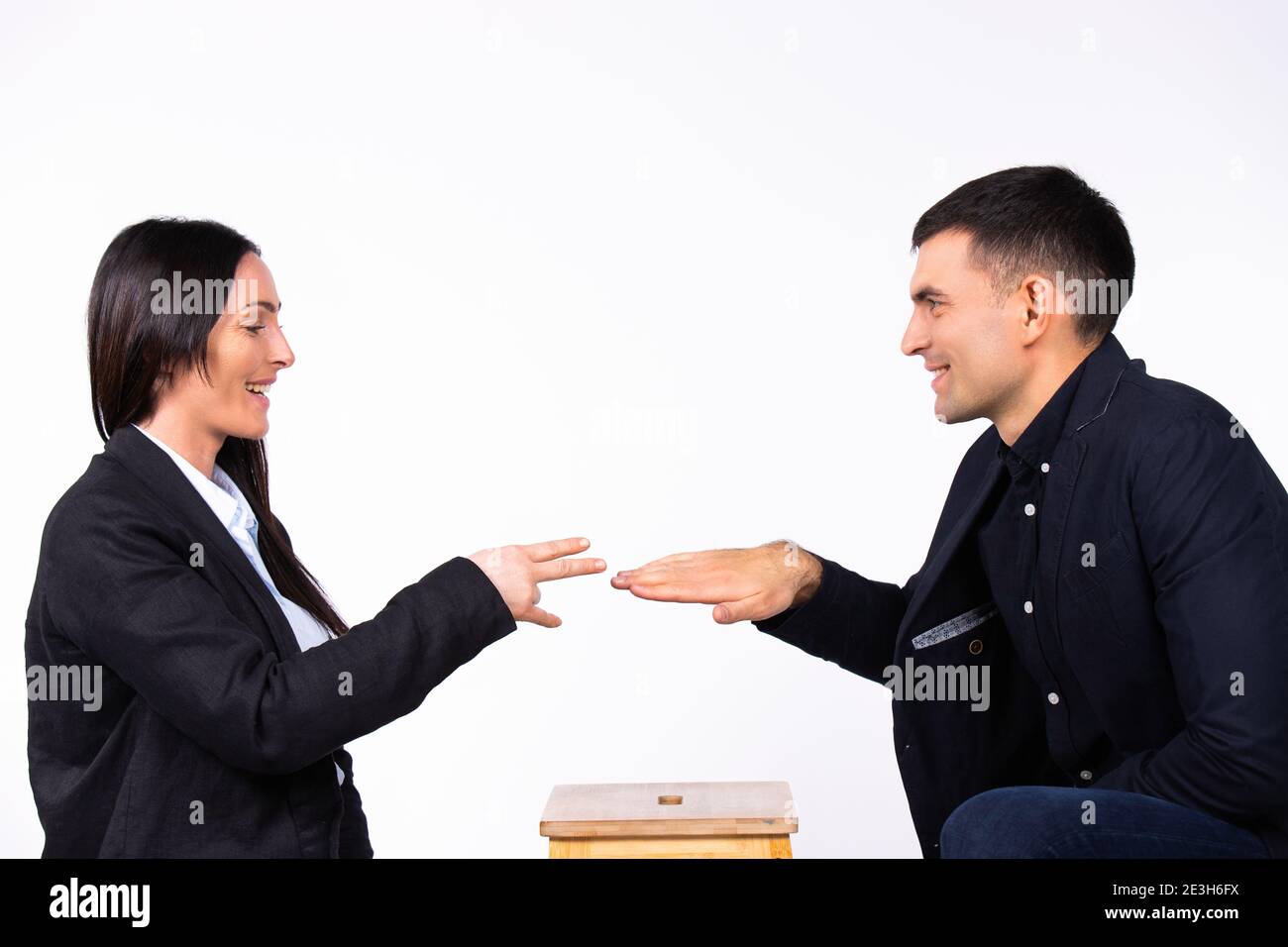 Competition of two young colleagues in office clothes on a white ...